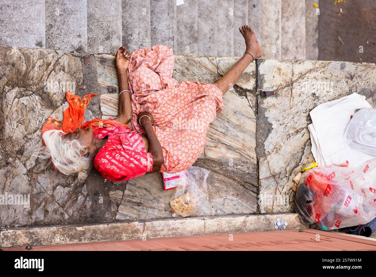 Poor elderly woman sleeping on the streets, Udaipur, Rajasthan, India ...