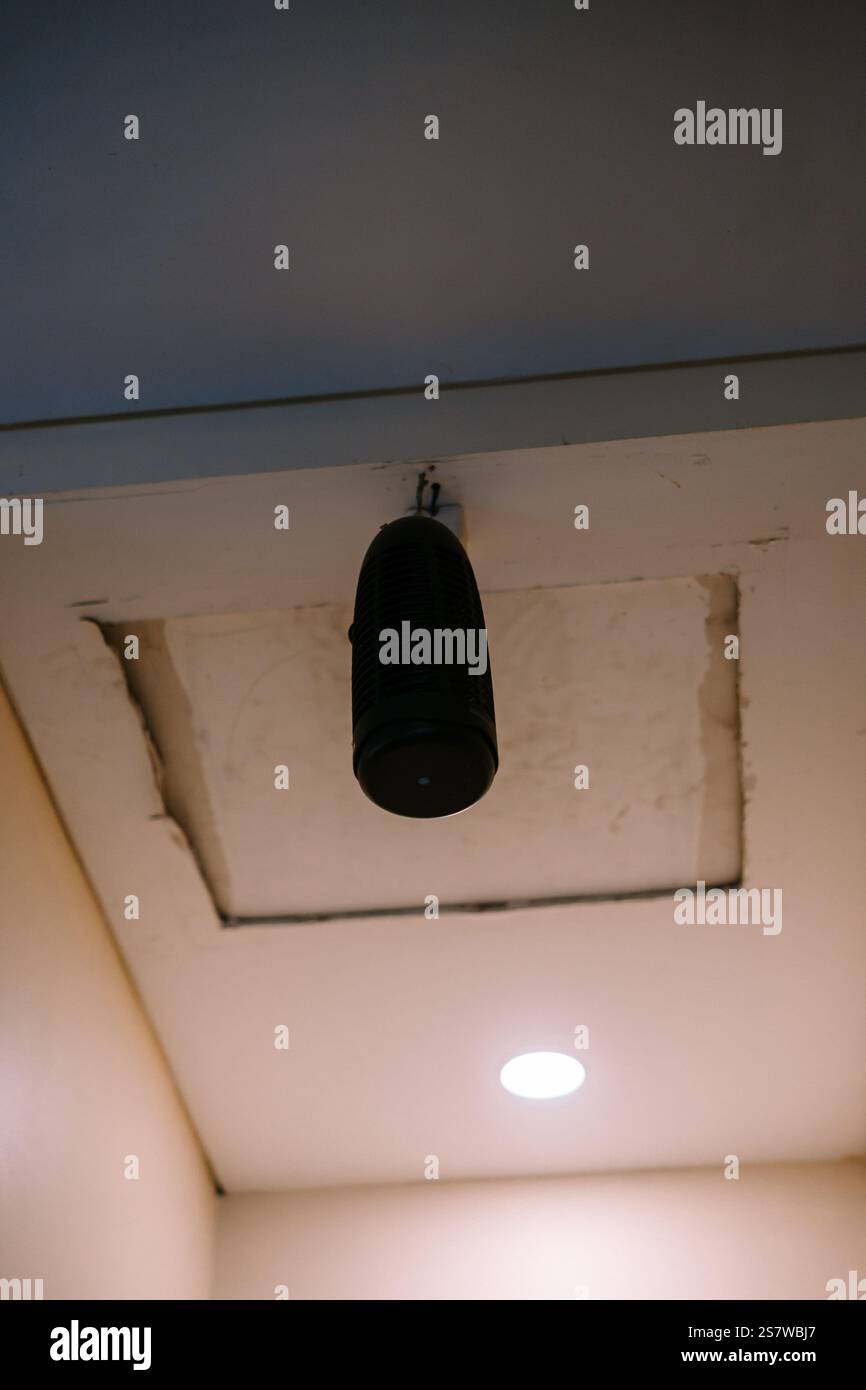 Modern smart speaker installed in ceiling, home automation, technology ...