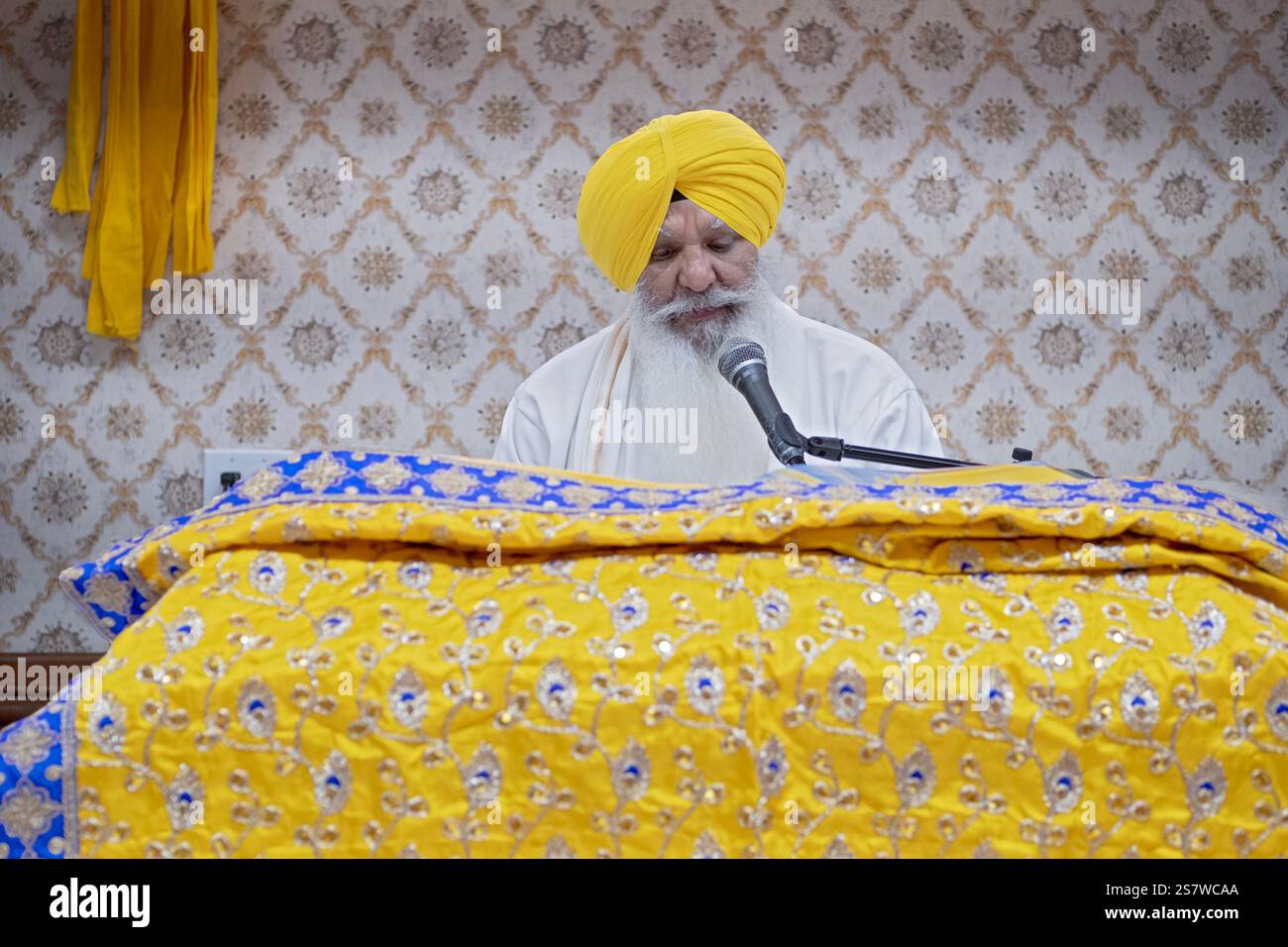 A Sikh priest reads from their holy book the Guru Granth Sahib that's ...