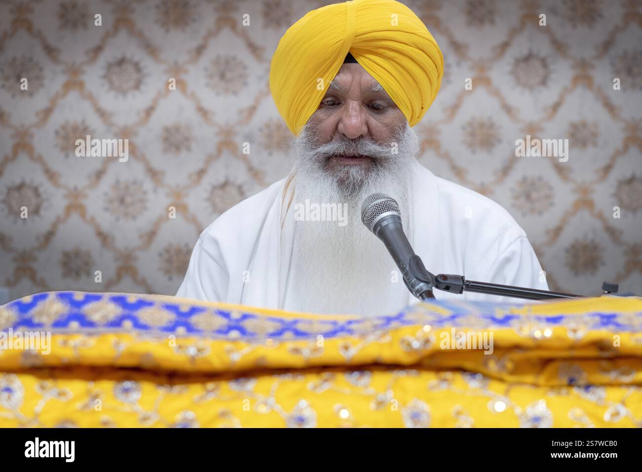 A Sikh priest reads from their holy book the Guru Granth Sahib that's ...