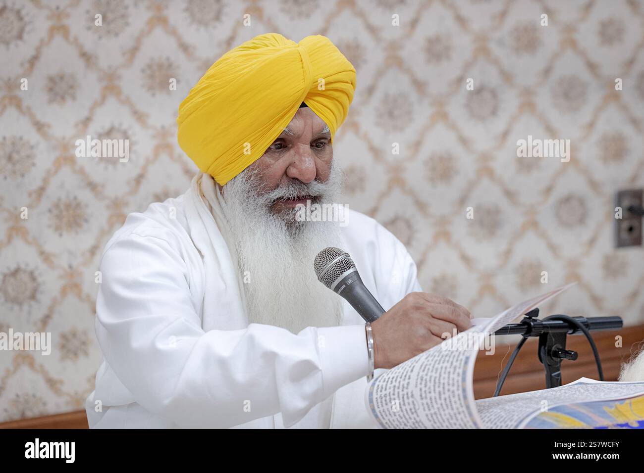 A Sikh priest reads from their holy book the Guru Granth Sahib that's ...