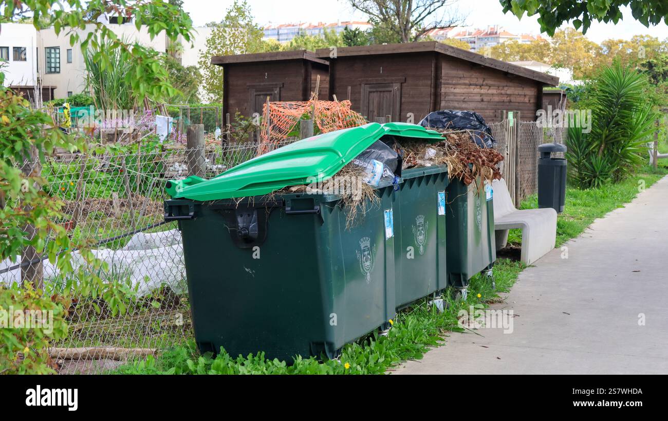 Overflowing green bins stand ready for organic waste disposal in an ...