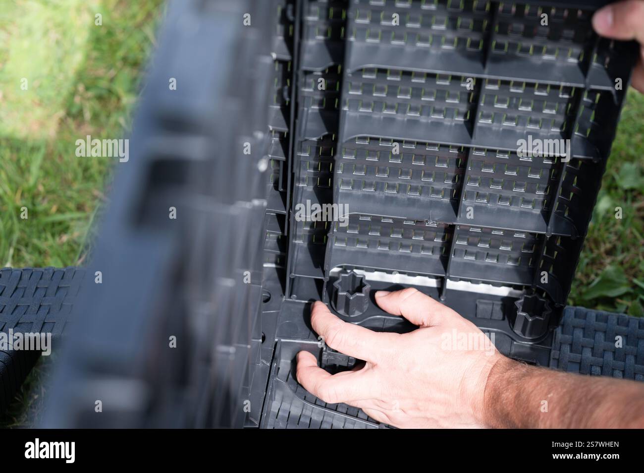 Assembling outdoor patio furniture. Close-up of hands connecting ...