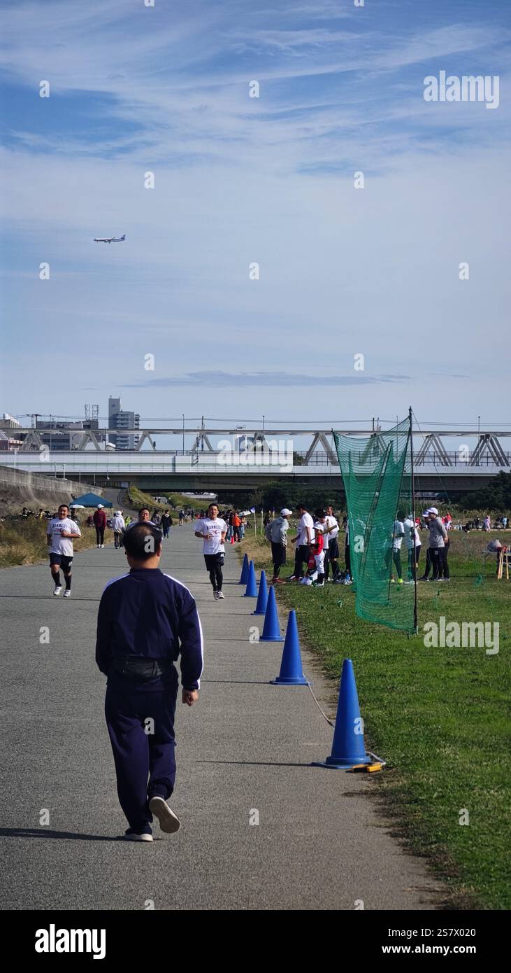 People doing outdoor sports at jogging track and baseball field near ...