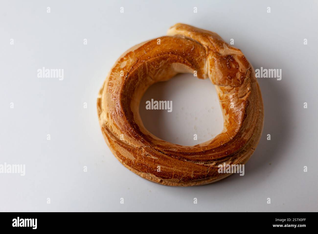 Homemade doughnut with butter and anise, captured in detail on a white ...