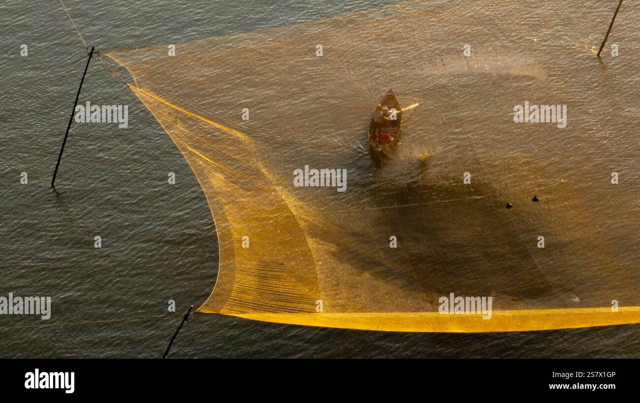 Fishermen using nets to catch fish is a common and traditional activity ...