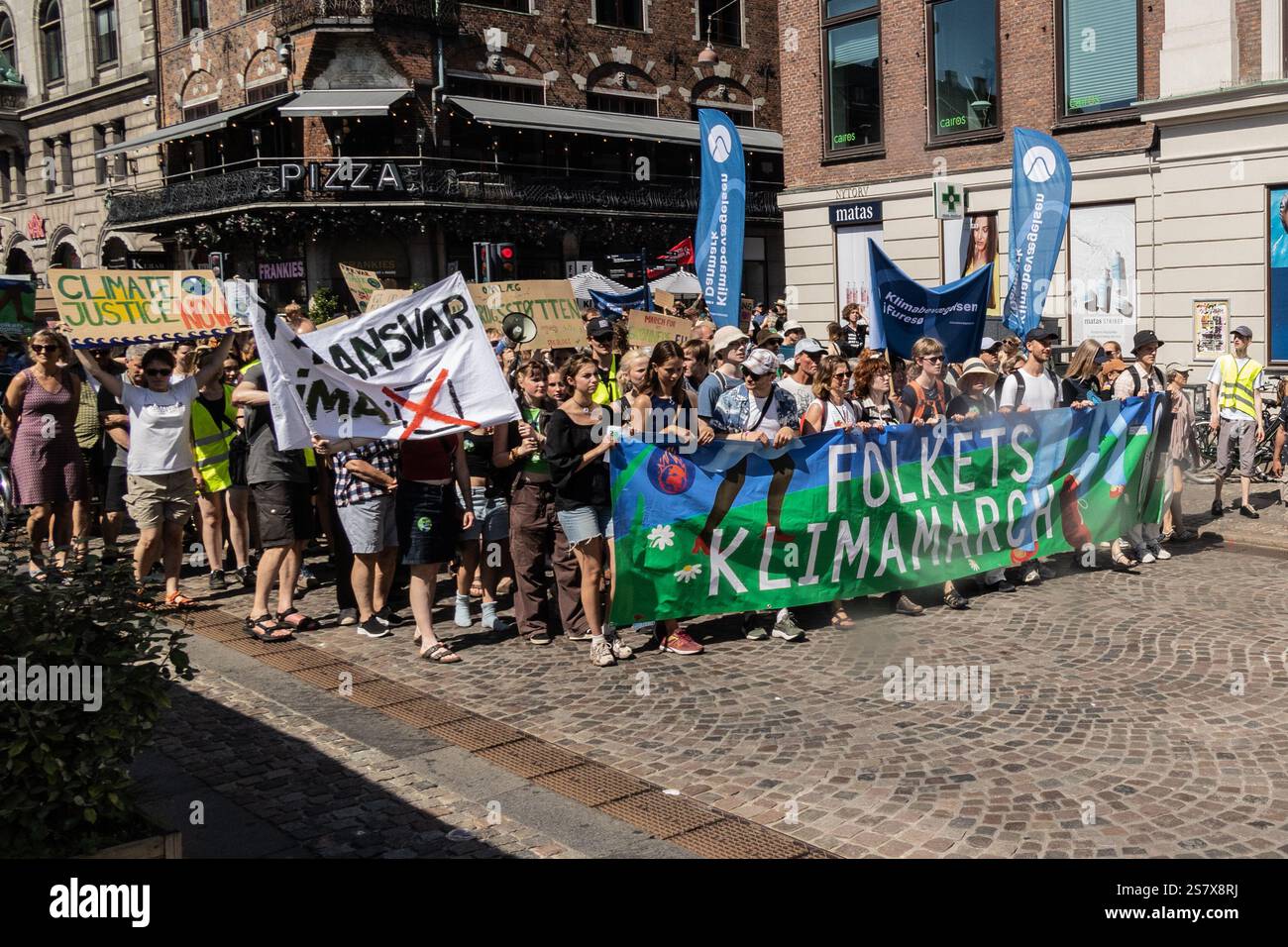 Protesters hold flags and a banner during the ’Folkets Klimamarch. The ...