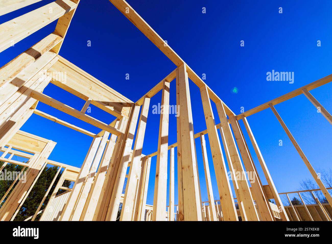 Workers are constructing wooden framework for building at sunlight ...