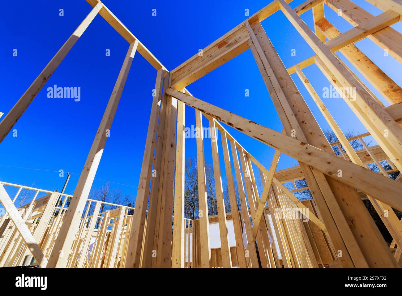 Wooden framework is beams being constructed for new house with clear ...