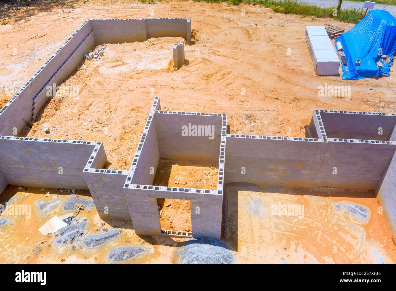 Preparing, laying concrete blocks for foundation of new building at ...