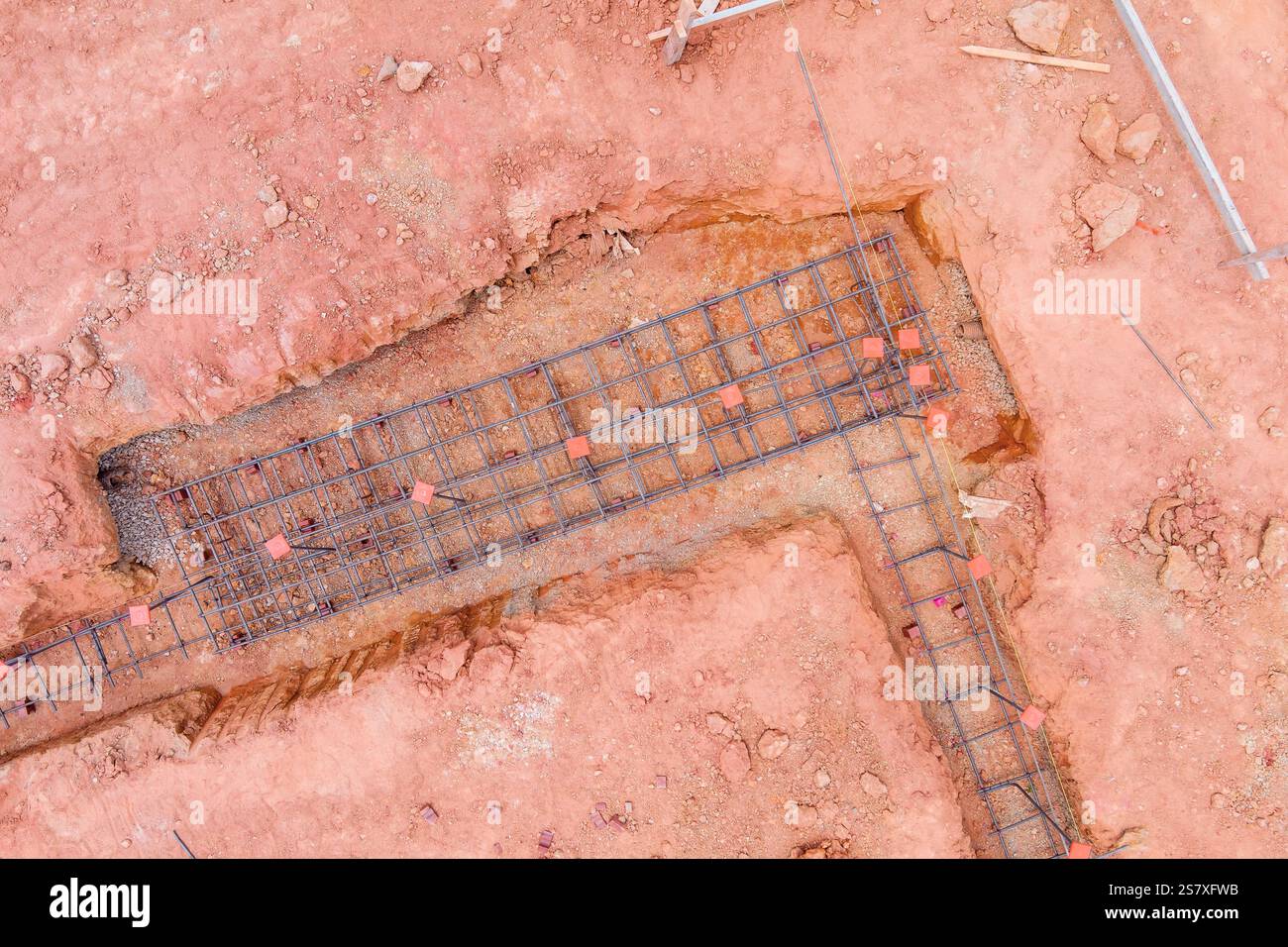 Prepare for foundation with rebar grids in dirt excavation, ensuring solid construction for ...