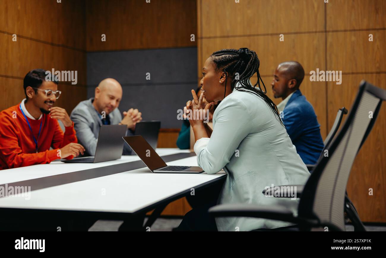 Business team seated around conference hi-res stock photography and ...