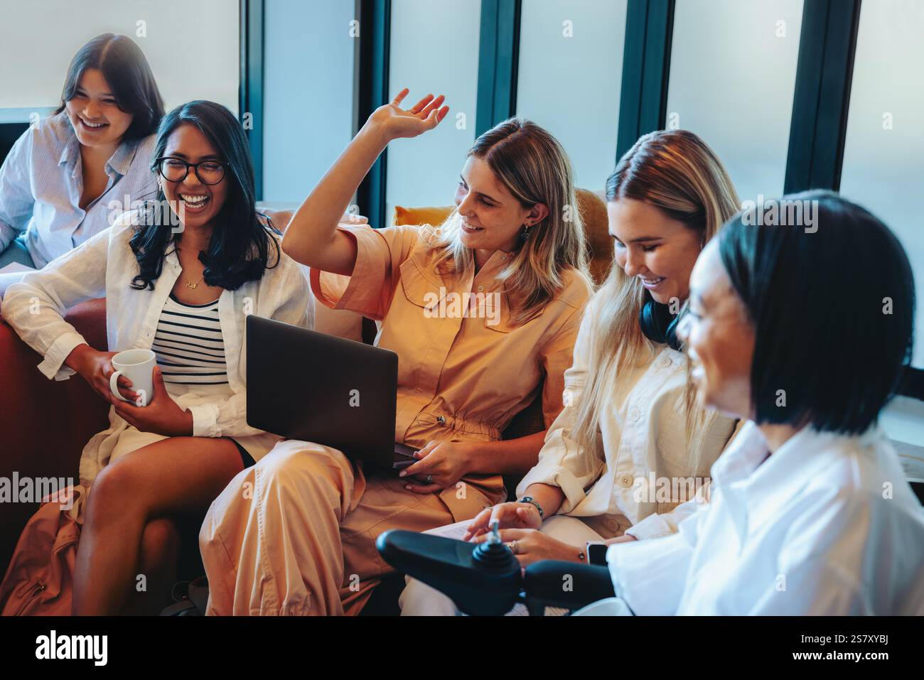 A group of female students engaged in a relaxed study session, enjoying ...