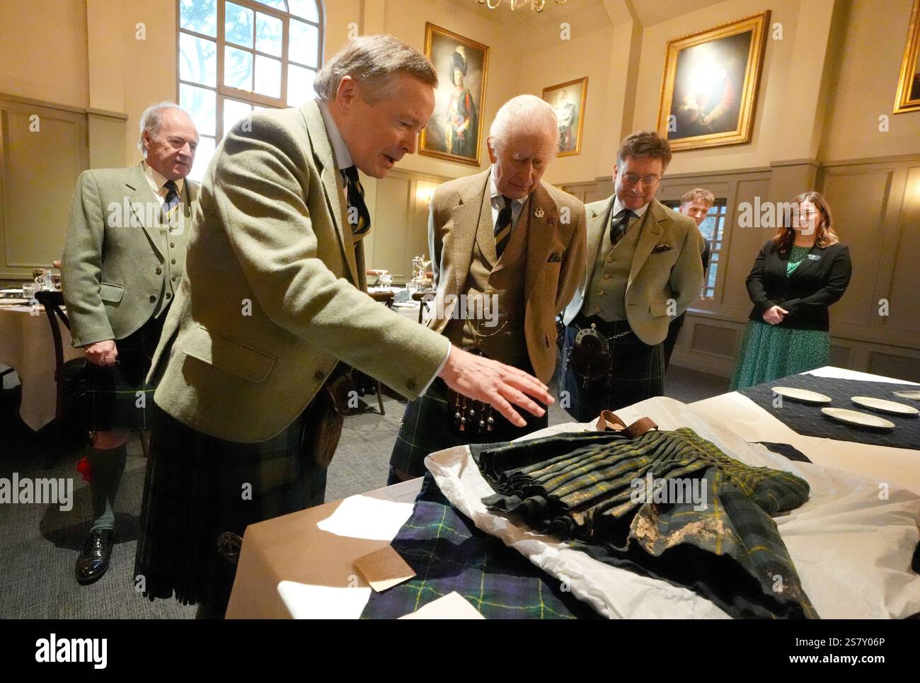 King Charles III meets Alexander 'Sandy' Manson as they view a kilt ...