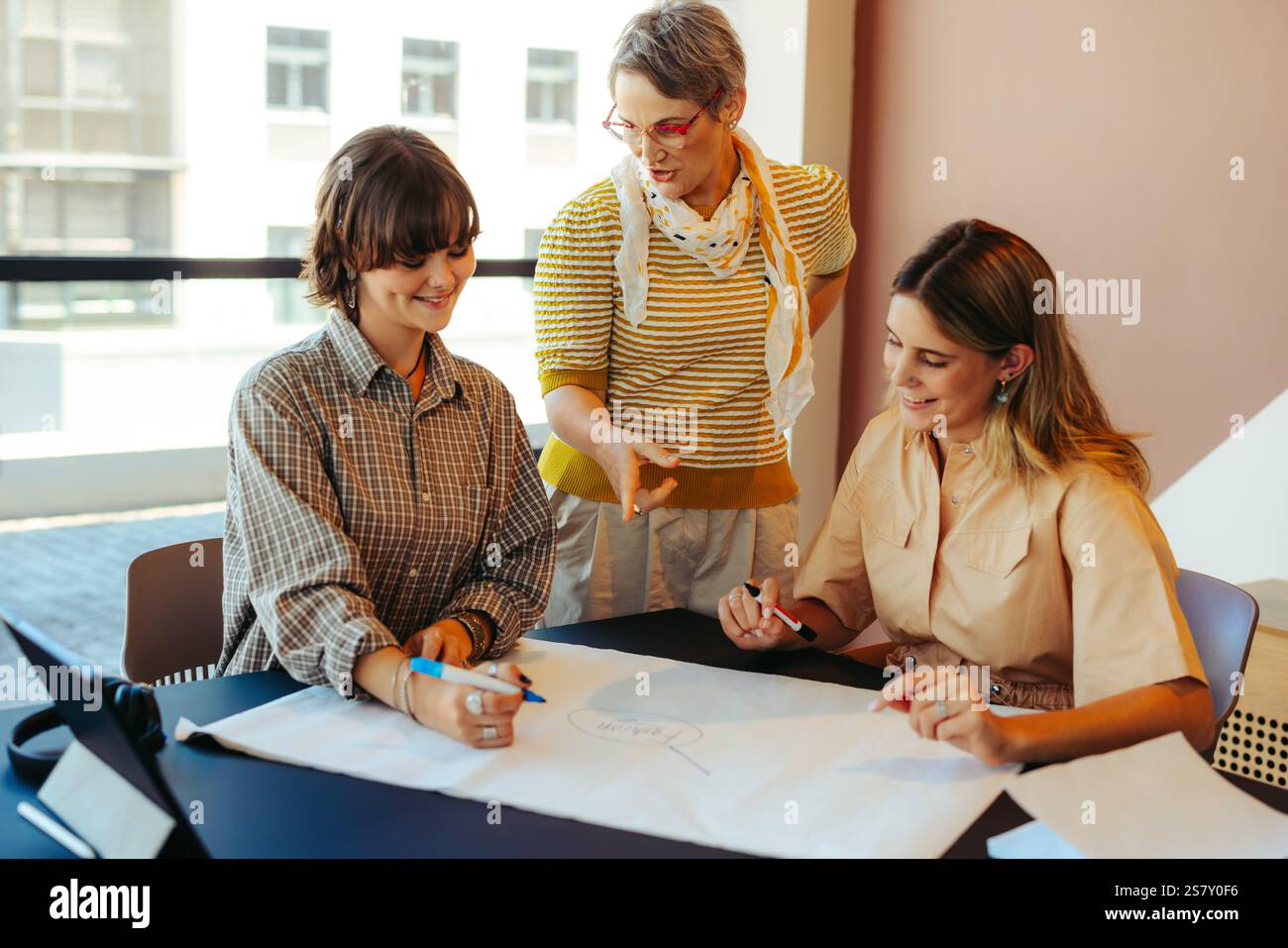 An engaging teacher oversees a brainstorming session with students in ...