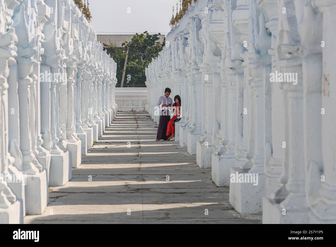 Mandalay, Myanmar: Kuthodaw Pagoda, Tripitaka tablets, Burmese couple in the Buddhist temple ...