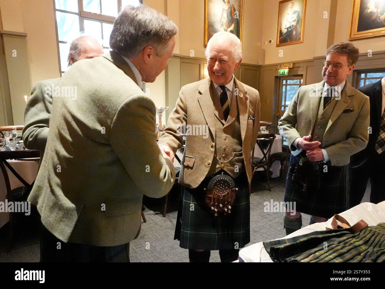 King Charles III meets Alexander 'Sandy' Manson as they view a kilt ...