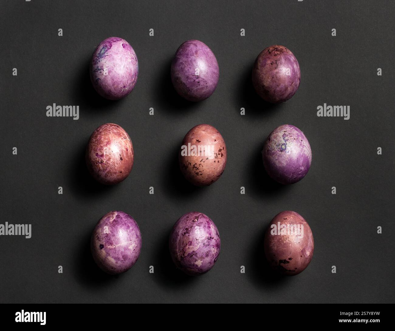 Colorful nine painted eggs for Easter on black surface. Easter flat lay ...