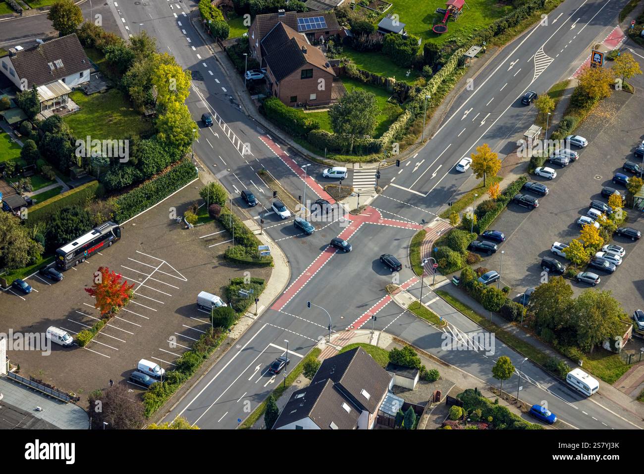 Aerial view, road traffic and red bicycle lane markings intersection ...