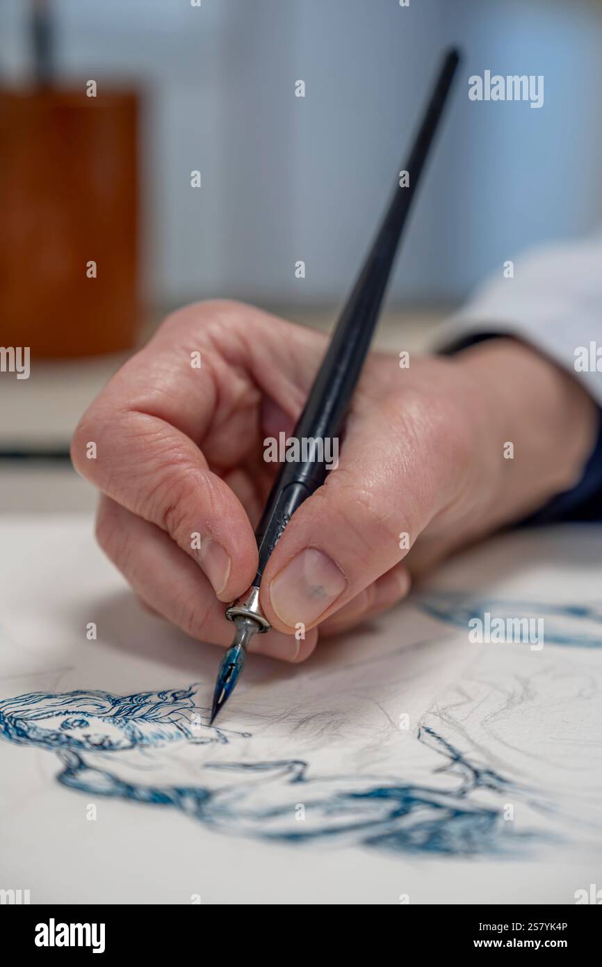 A woman's hand draws a woman in blue ink with a quill pen during a ...