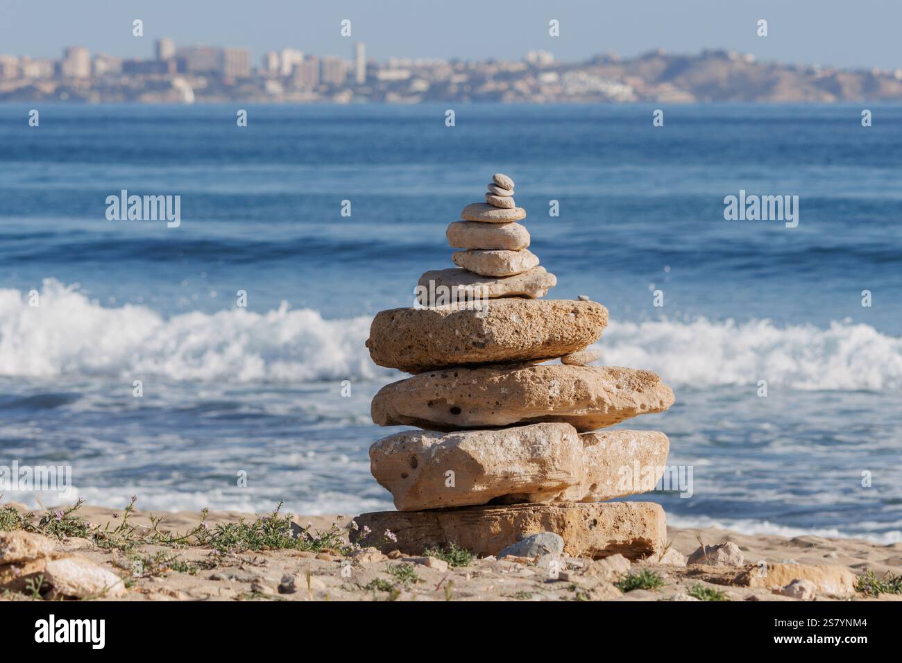 Stacked stones on Agua Amarga dog beach in Alicante, Spain Stock Photo ...