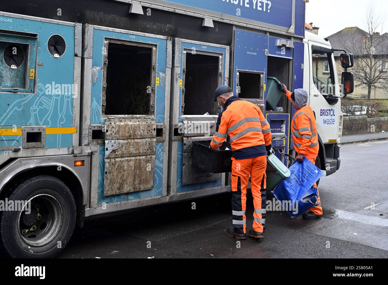 Workman emptying recycling boxes into Bristol waste recycling lorry ...