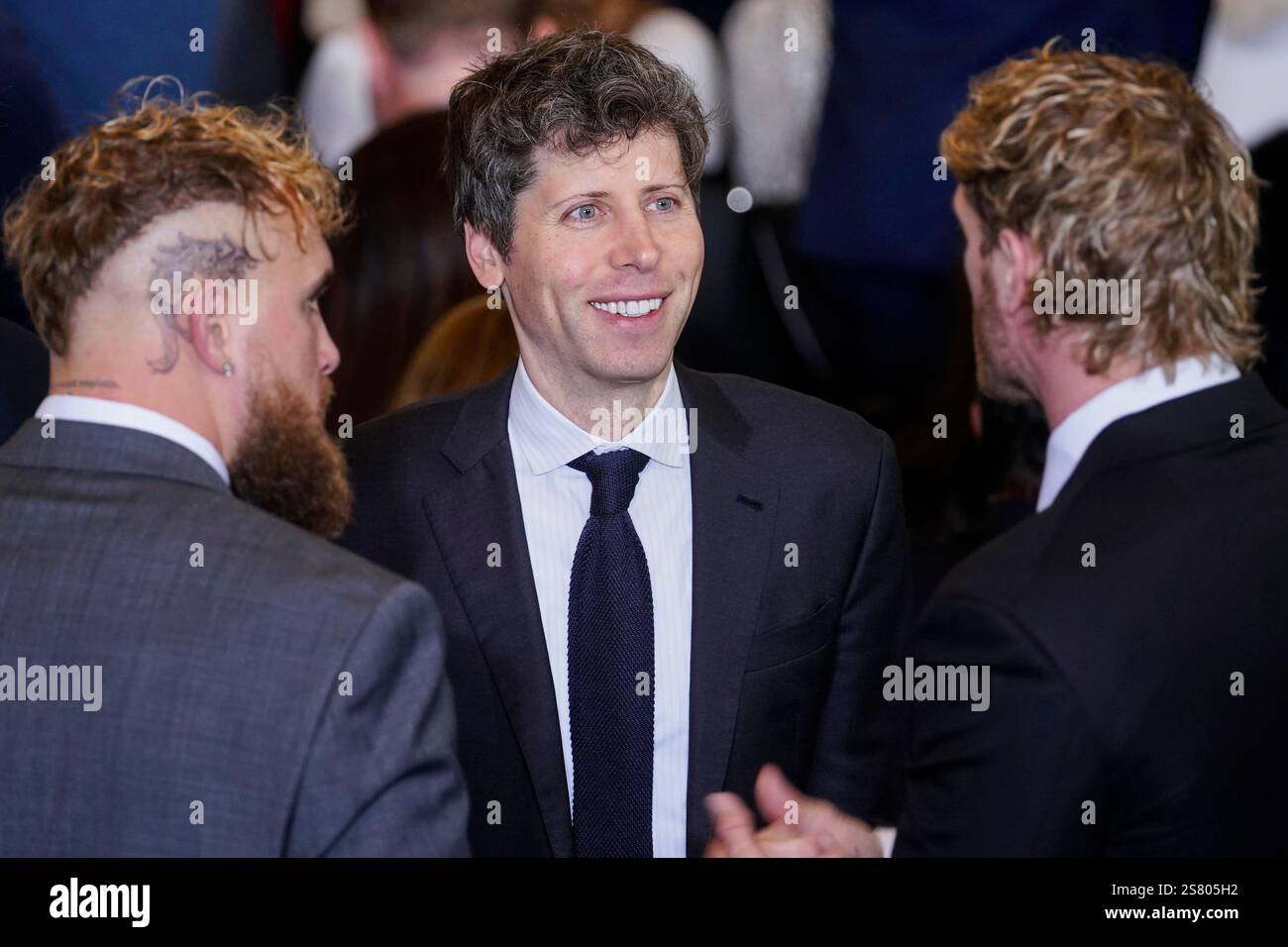Open AI CEO Sam Altman, center, speaks with boxer Jake Paul and ...