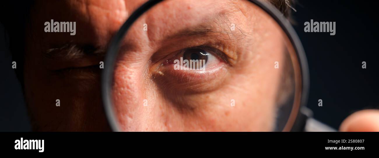 Private investigator detective with magnifying glass, selective focus ...