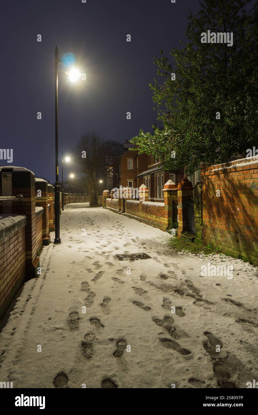 Street lighting along the snow covered river Wye footpath Hereford ...