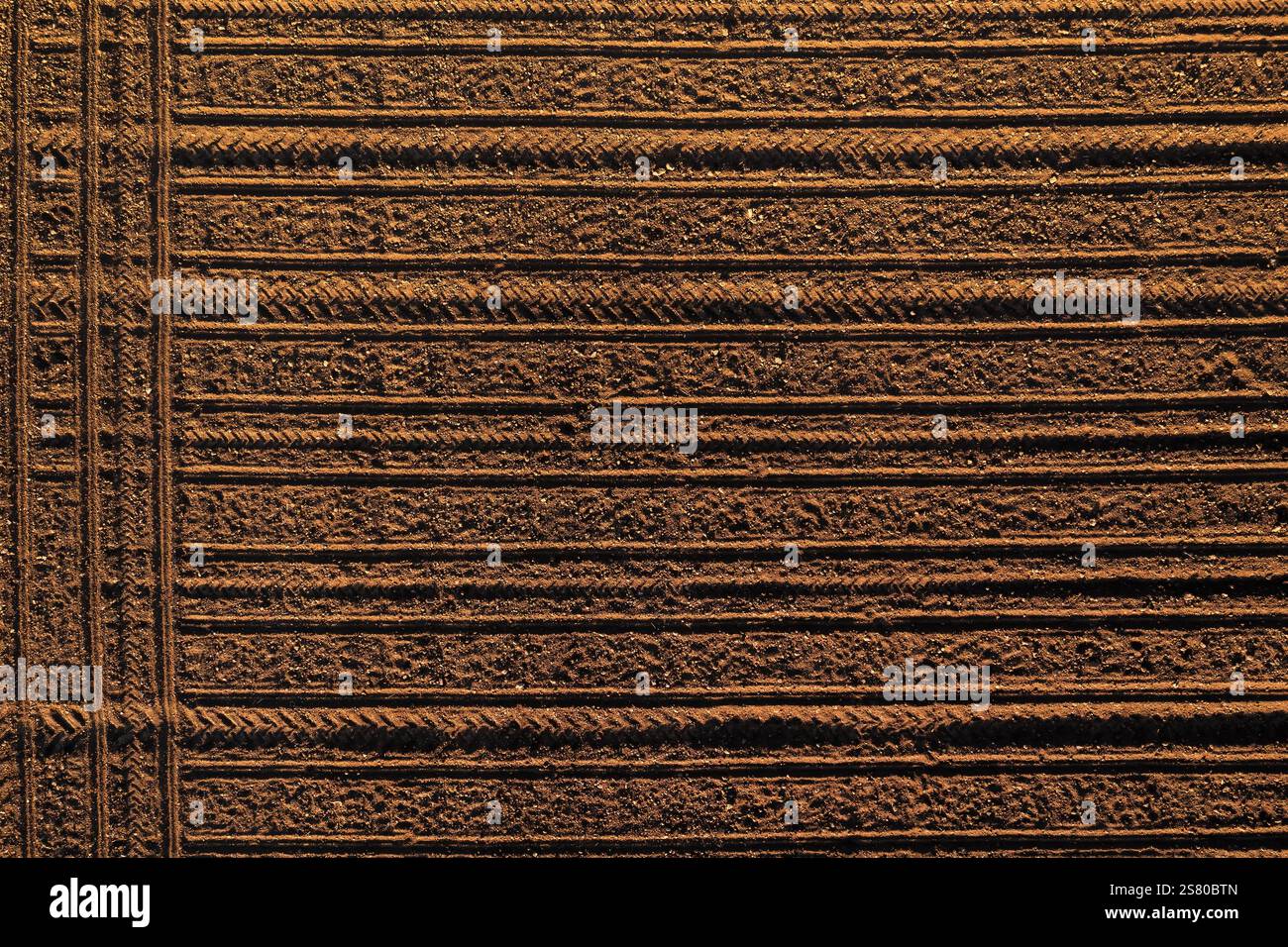 Tractor tread marks forming forming pattern in plowed field soil ...