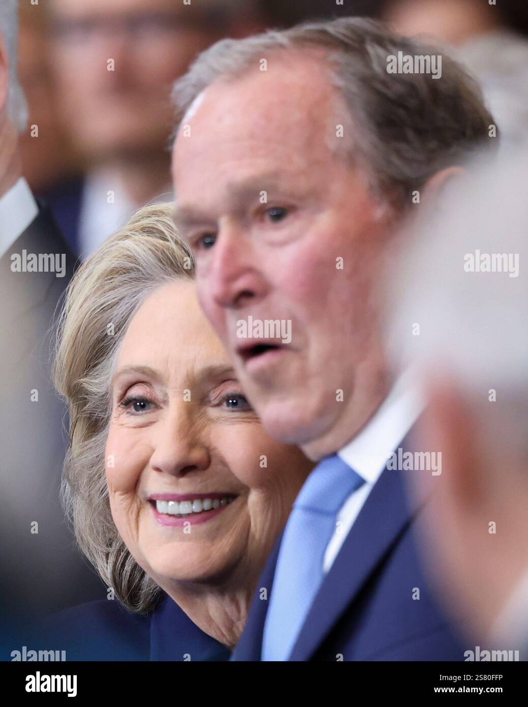 Former U.S. Secretary of State Hillary Clinton and former U.S. President George W. Bush react ...