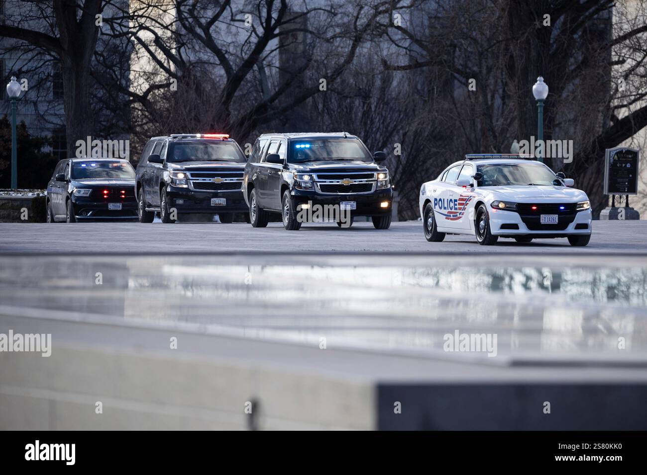 A motorcade arrives at the U.S. Capitol building ahead of the ...