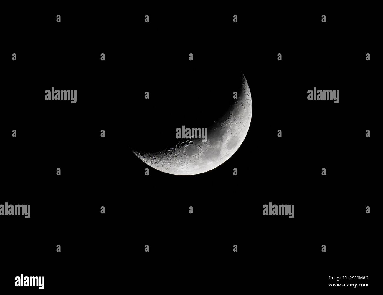 Crescent moon with great details of its craters at night Stock Photo ...