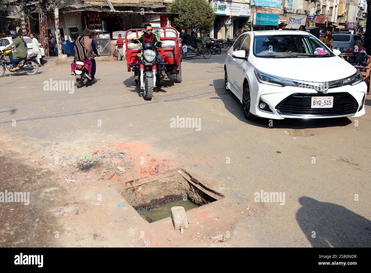 Commuters pass through nearby an open sewerage main hole that may cause ...