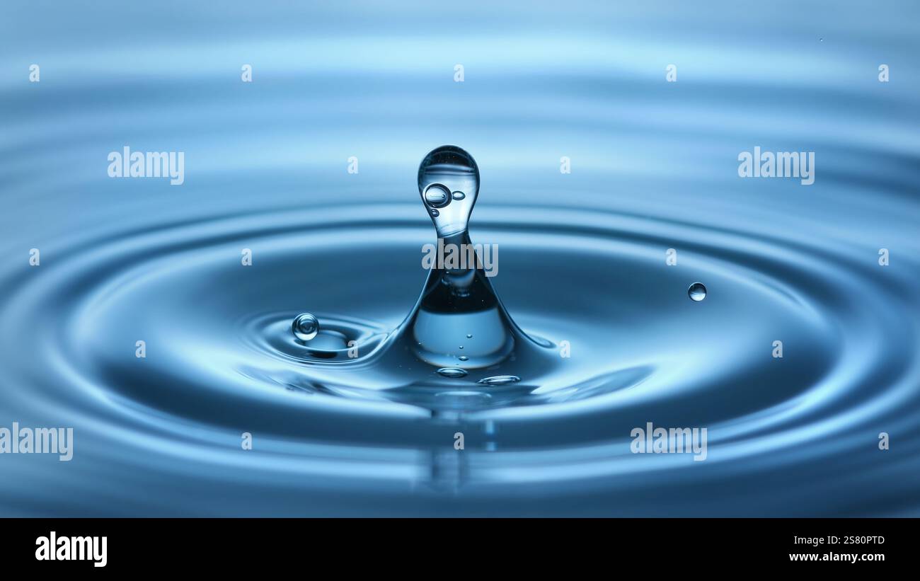Clear water drop with small bubbles trapped in it, making ripples in ...