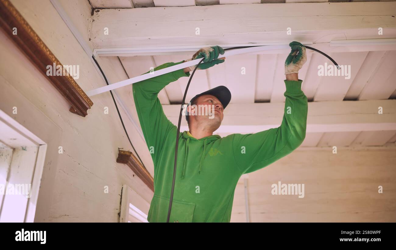 An electrician conducts wiring in a wooden house Stock Photo - Alamy