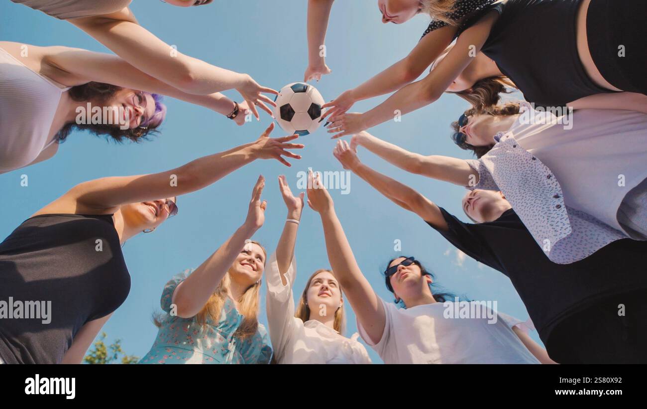 High school students showing unity and teamwork as they reach for a ...