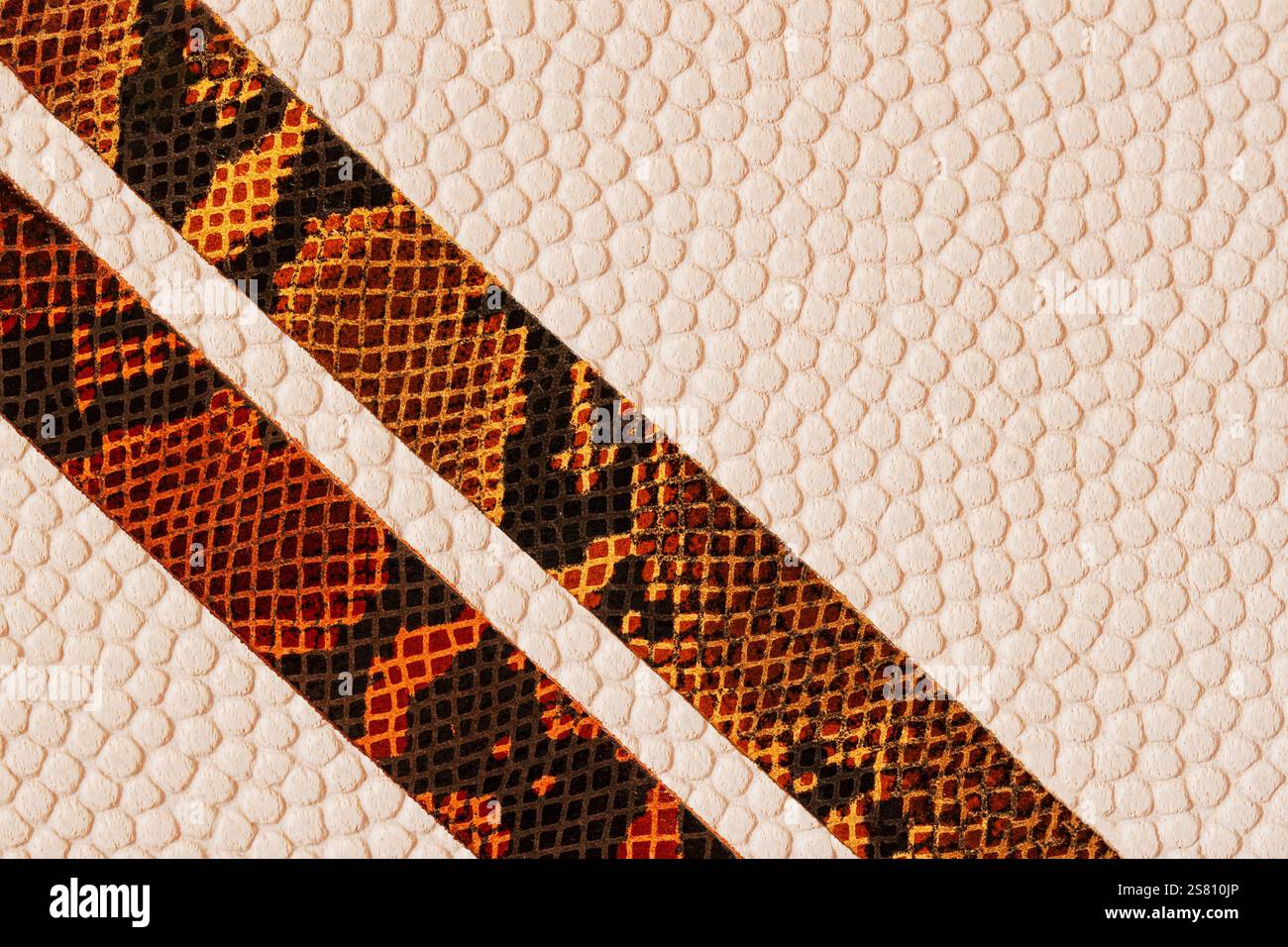 Diagonal close-up view of snake skin pattern on beige leather. Textures ...