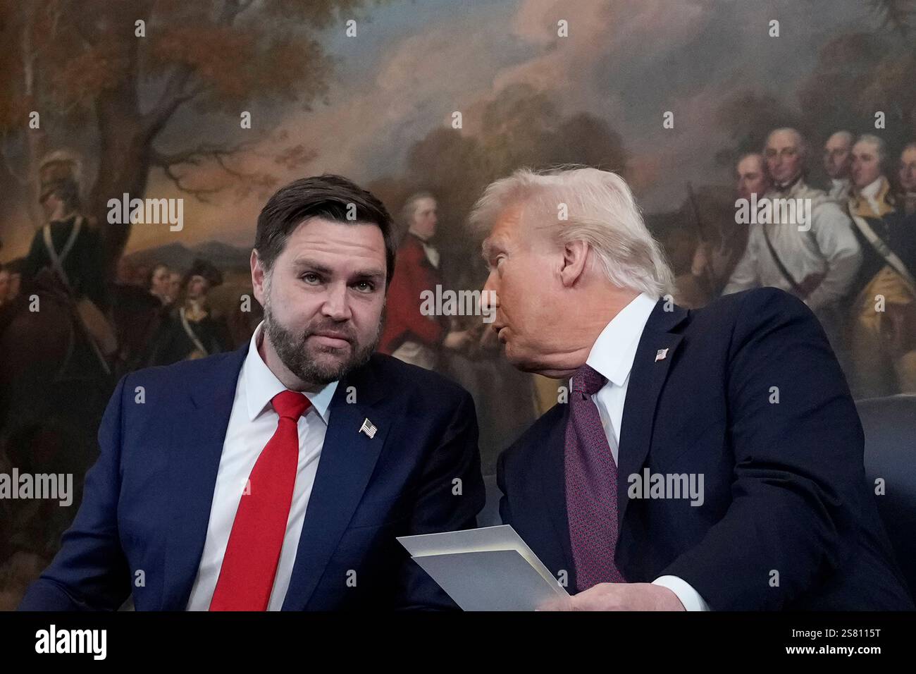 Donald Trump speaks with JD Vance, left, before taking their oaths of ...