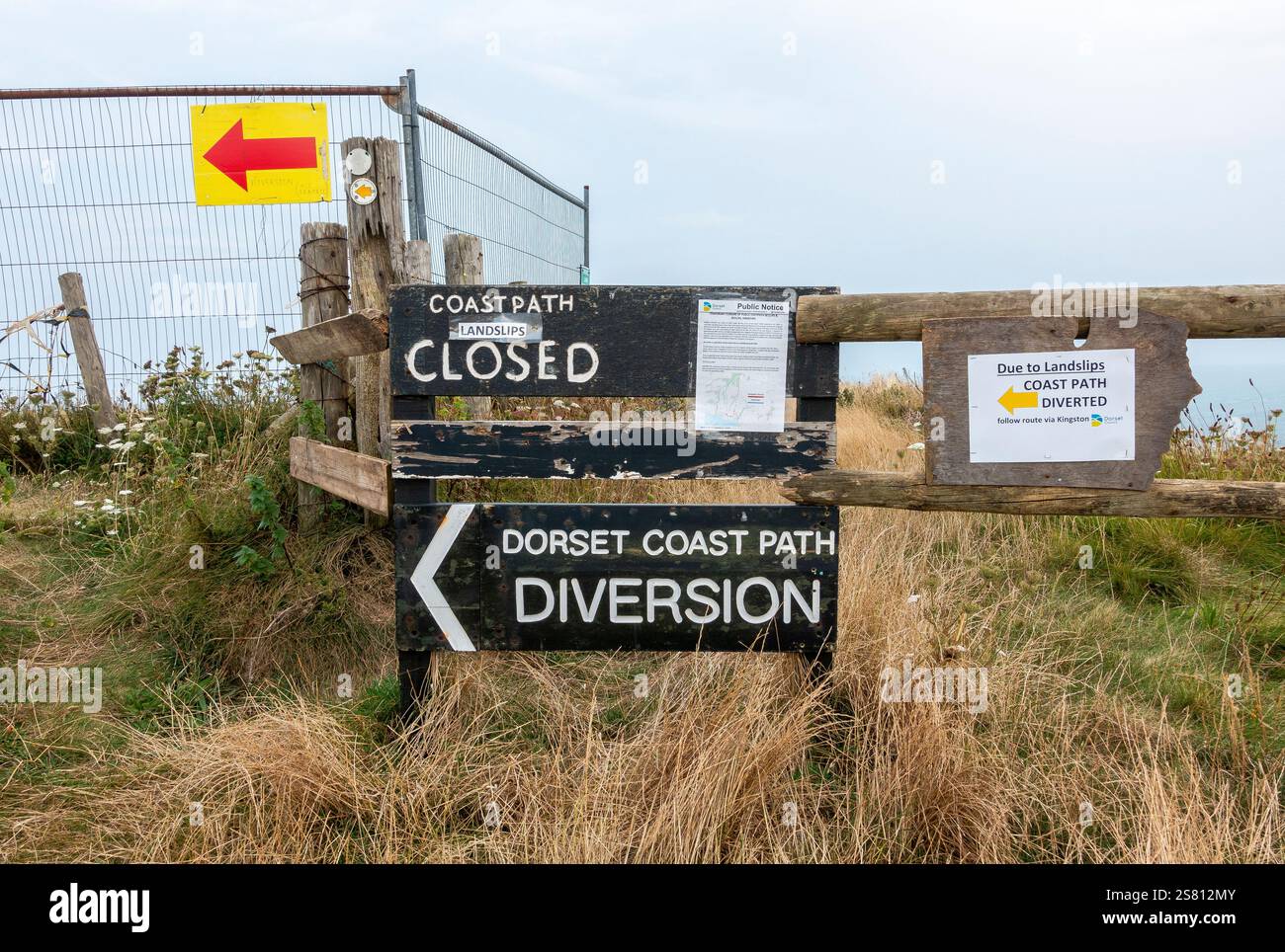 Sign indicating landslides, access restrictions and coastal path ...