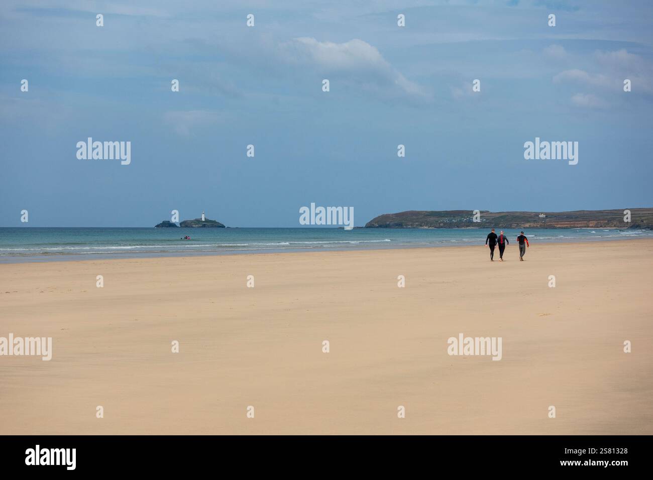 Visitors enjoy a peaceful walk along Gwithian sandy beach in Cornwall ...