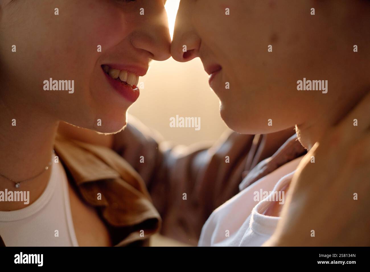 Medium close up of unrecognizable couple touching noses and smiling ...