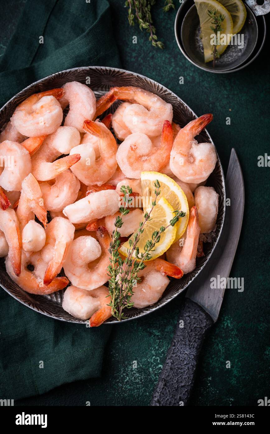 Frozen uncooked prawns or shrimps with lemon Stock Photo - Alamy