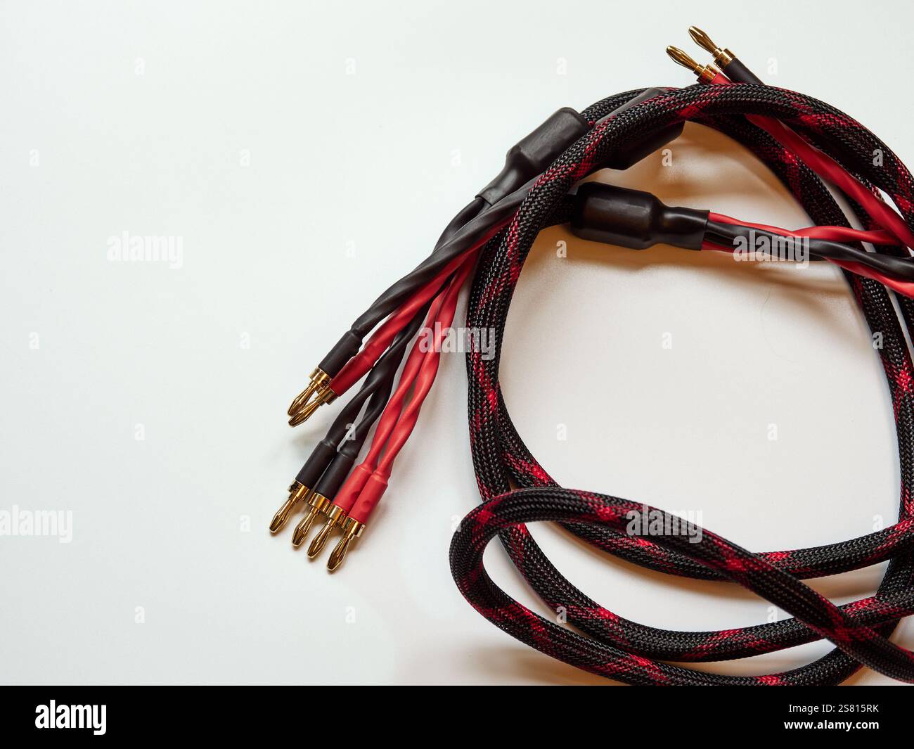 Twisted audio cables with gold connectors on a white surface Stock ...