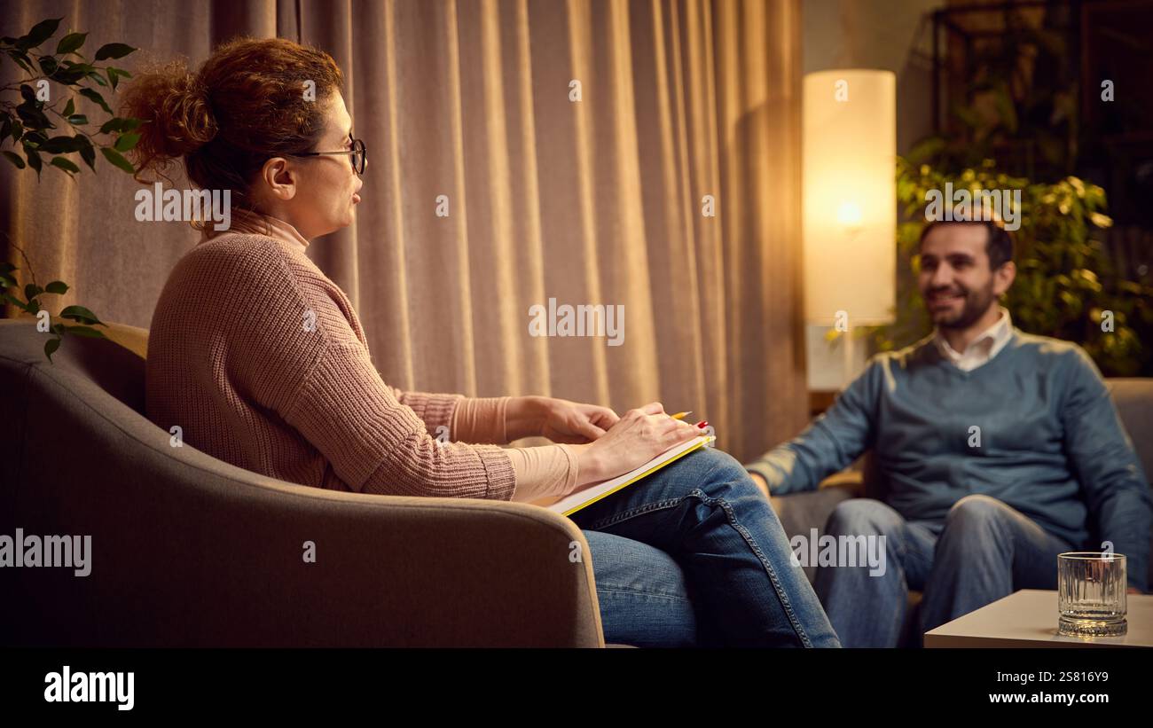 Female psychologist with notes explaining something to a male client ...