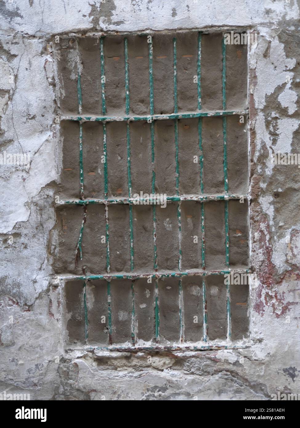 Barred and bricked up cellar window in Cadiz Spain Stock Photo - Alamy