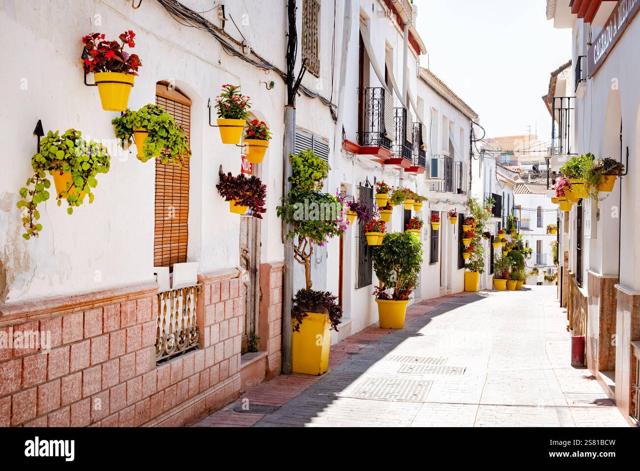 Estepona, Spain. A narrow street in the old town lined with white ...