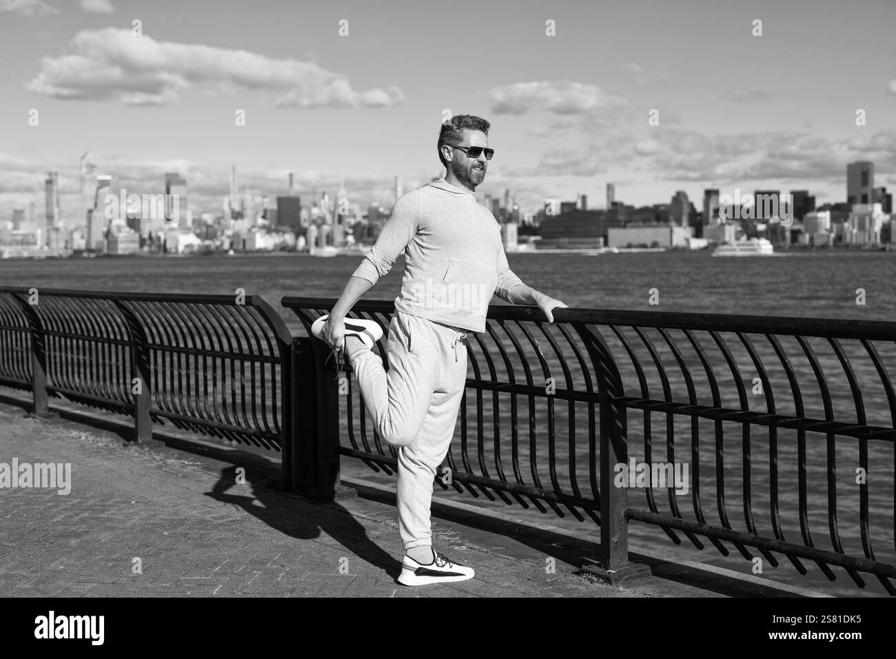 Sportsman stretching muscles after running. Sportsman stretch to ...