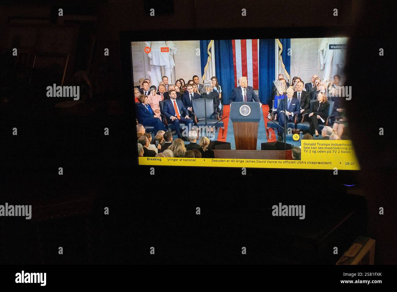 A Danish woman watches coverage of the Presidential inauguration of ...