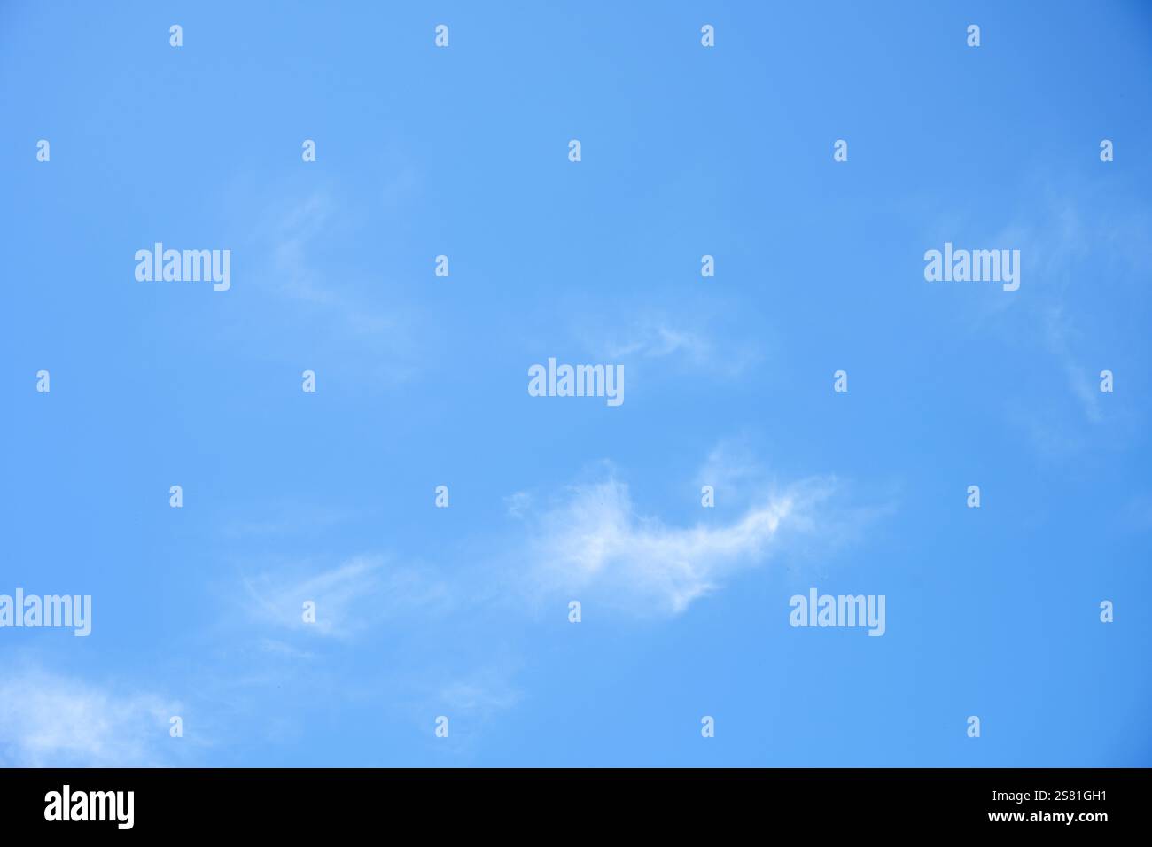 Very clear sky with a group of clouds floating along pushed by the wind ...